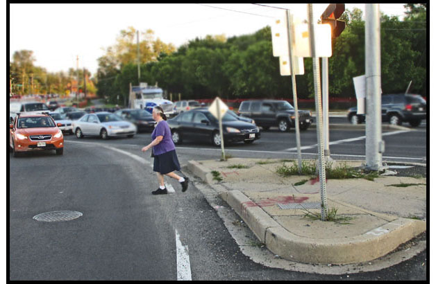 Photo shows a person crossing a lane of right-turning traffic, starting ...
